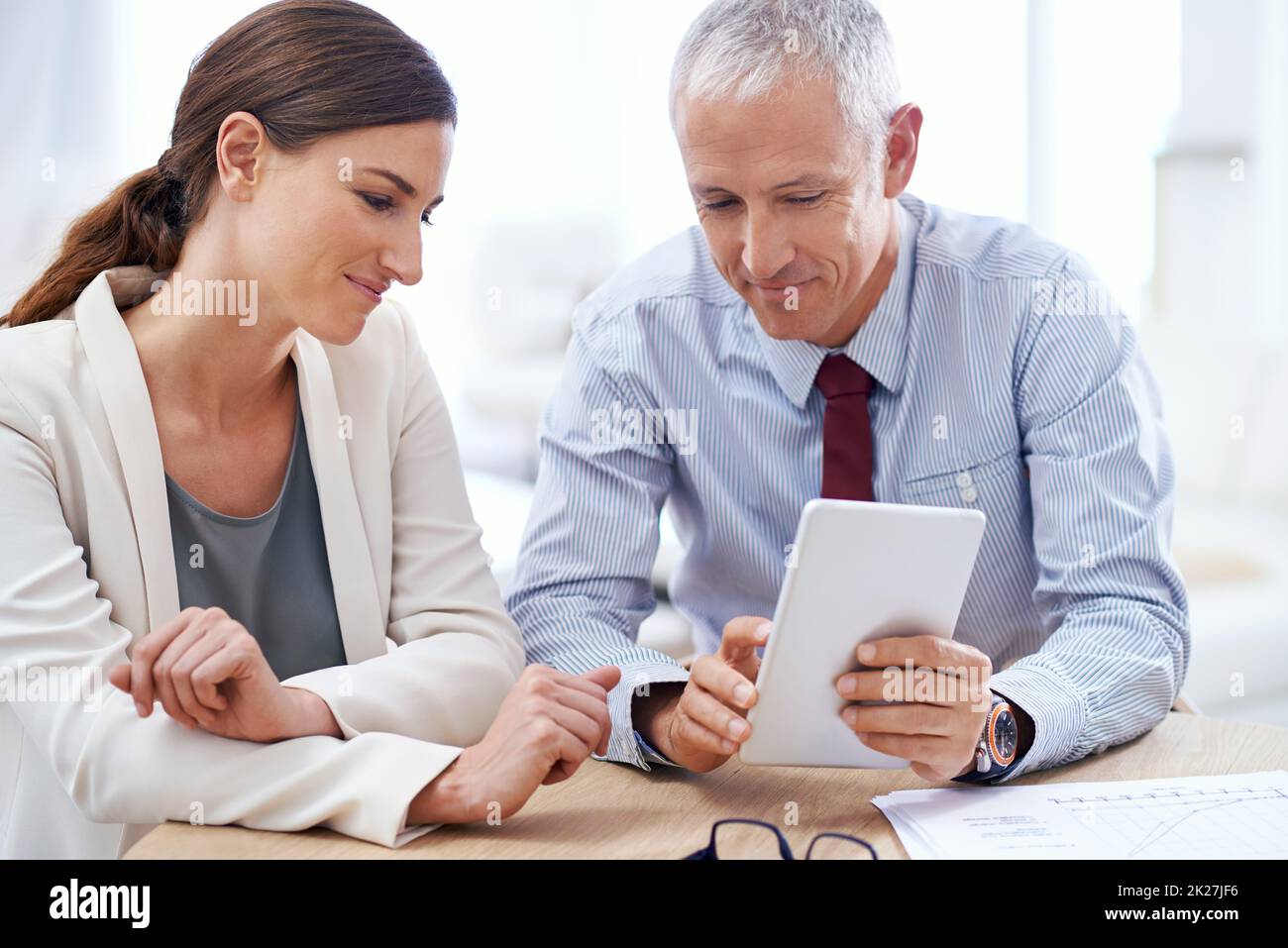 Technology helping meetings run smoothly. two colleagues using a ...