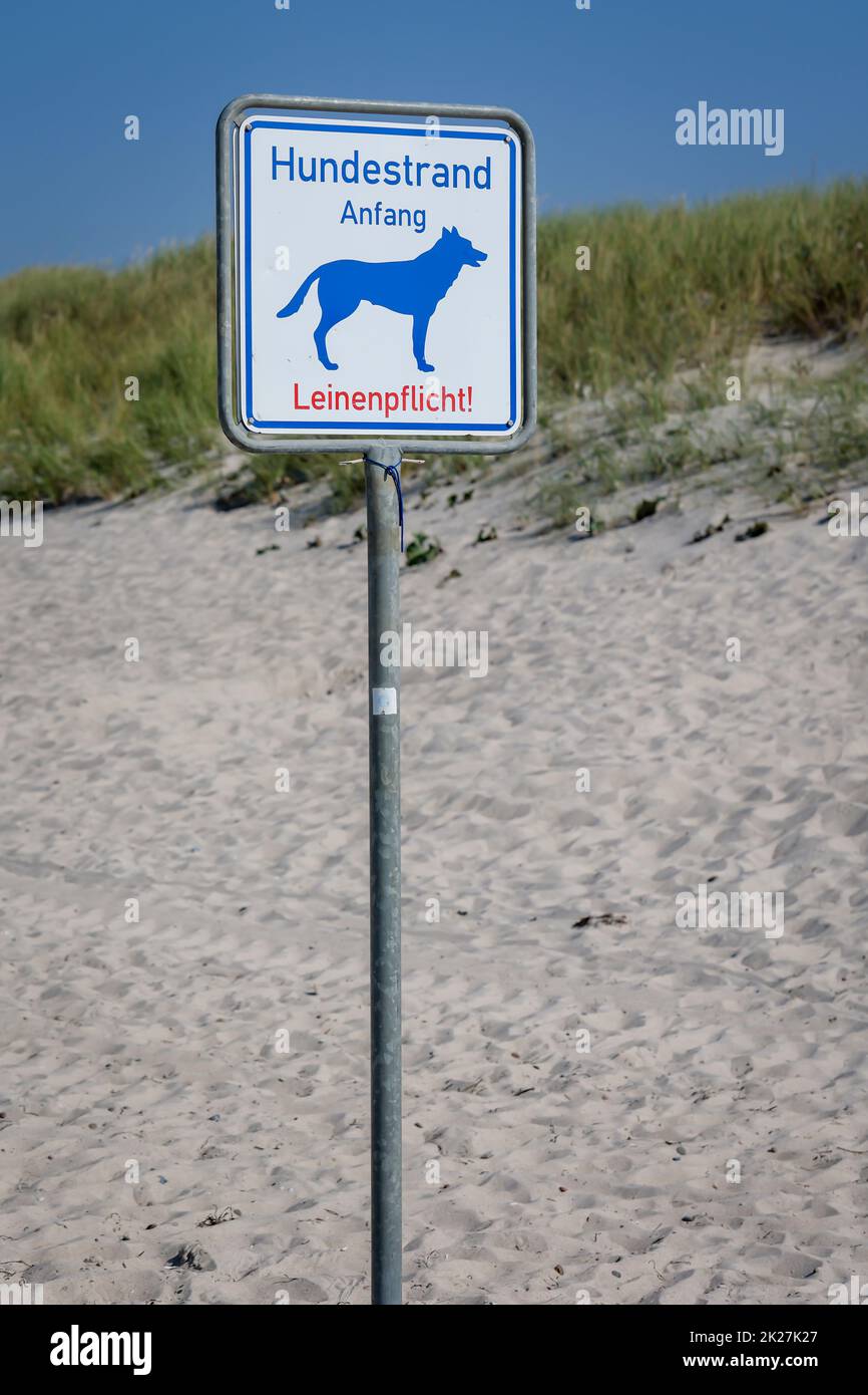 On the beach, dog beach on the Baltic Sea, there is a sign marking the ...
