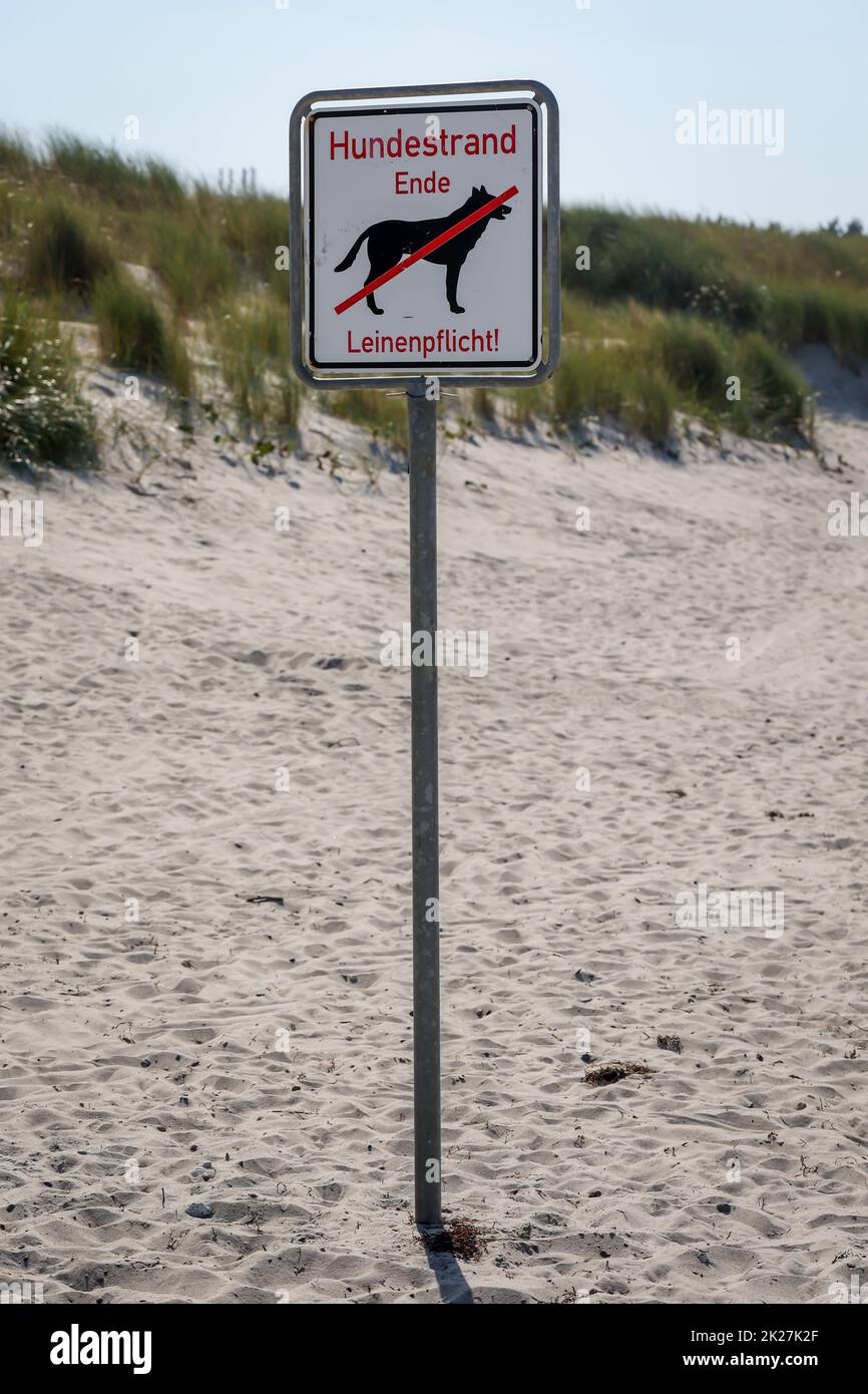 On the beach, dog beach on the Baltic Sea, there is a sign marking the ...