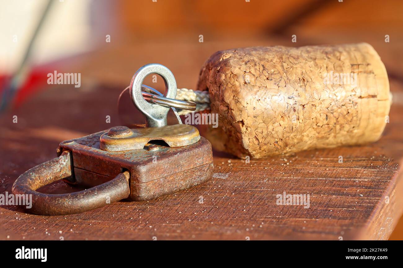 A key for a lock, padlock with a cork tag Stock Photo - Alamy