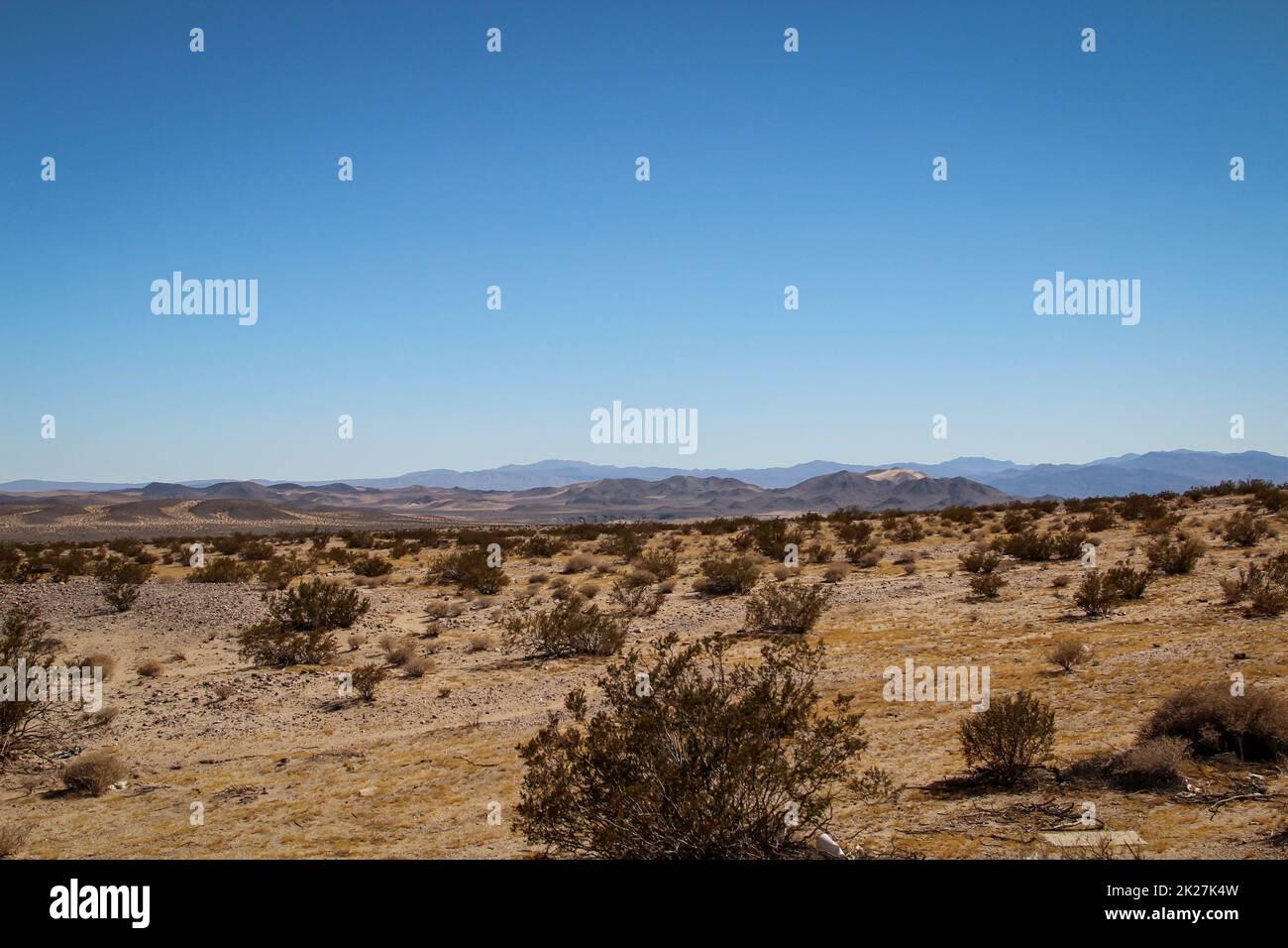View of the Nevada desert. Lots of sand, mountains and little ...