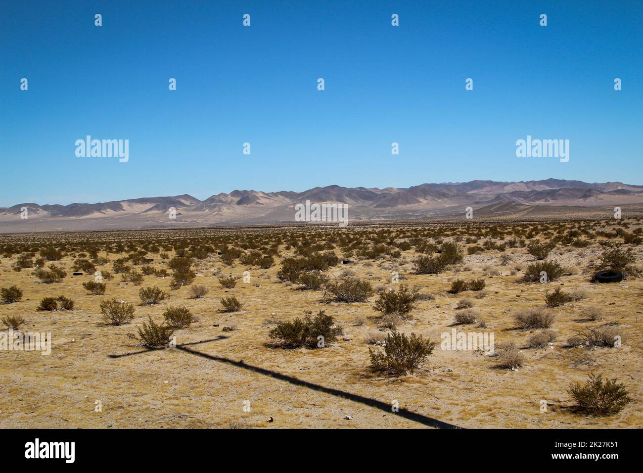 View of the Nevada desert. Lots of sand, mountains and little ...