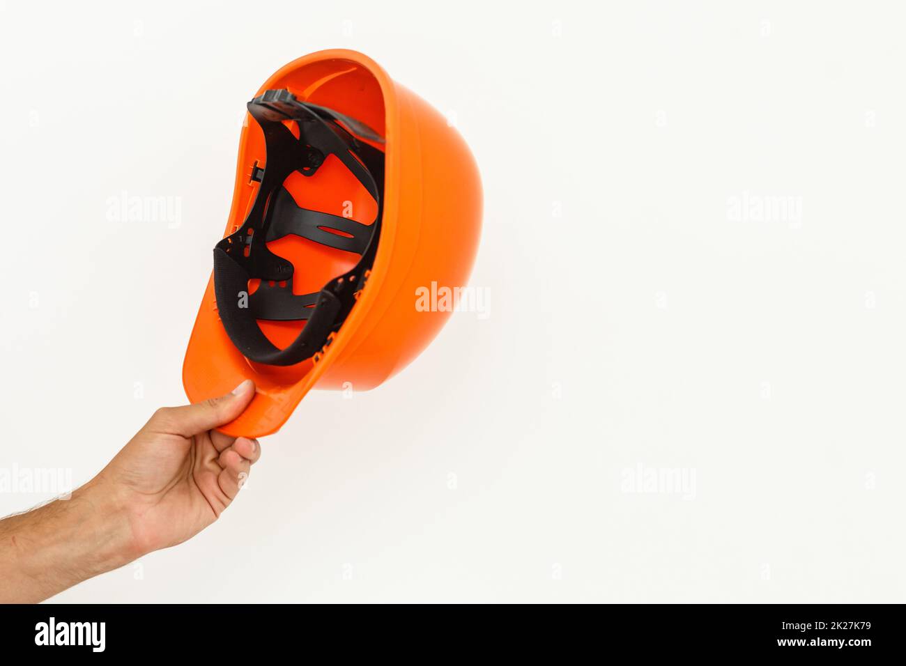 Male Hand with yellow safety helmet. Human Hand holding hard hat ...
