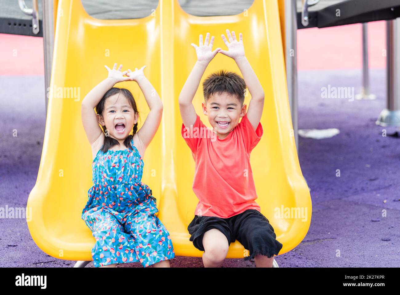 Asian child smiling playing on slider bar toy outdoor playground Stock ...