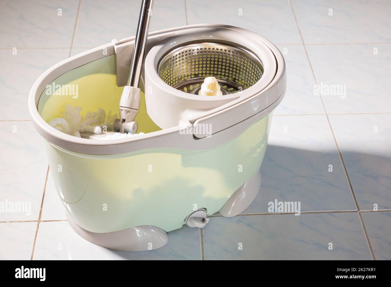 Mop with microfiber head spinning on the bucket Stock Photo - Alamy