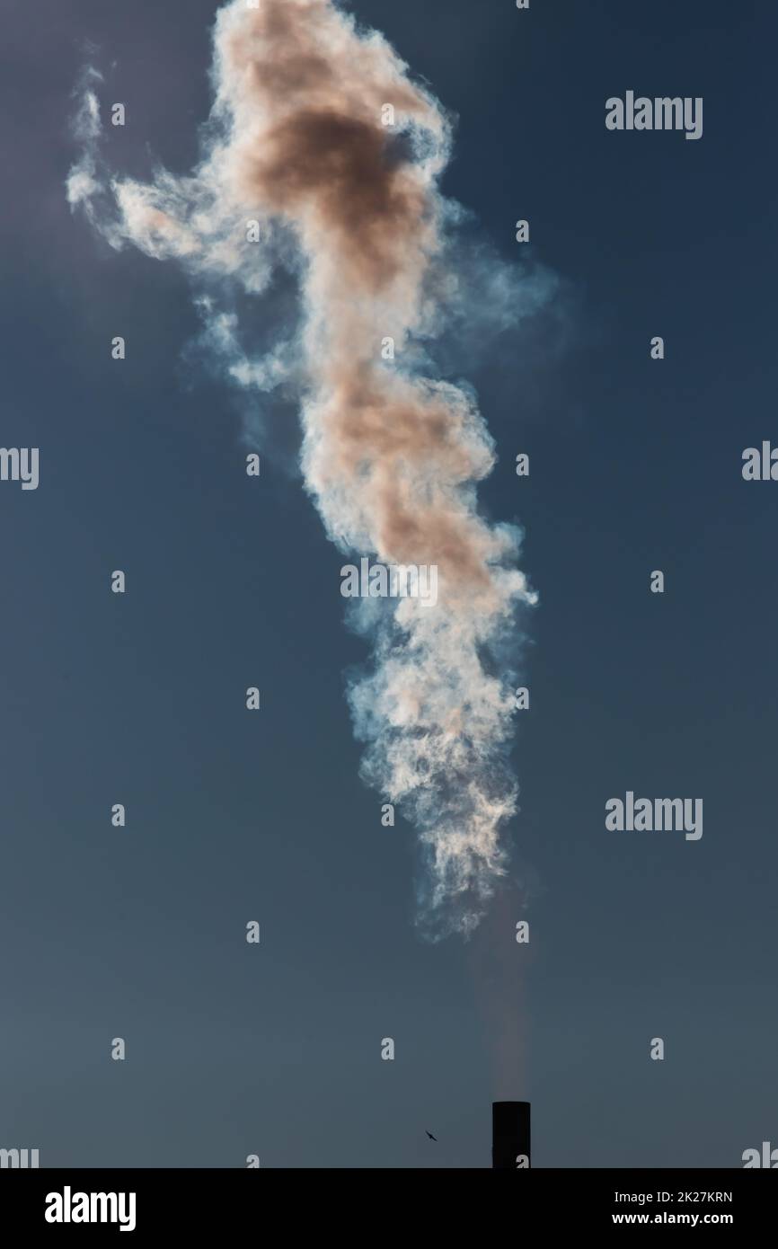 Smoke coming out of factory chimney Stock Photo - Alamy