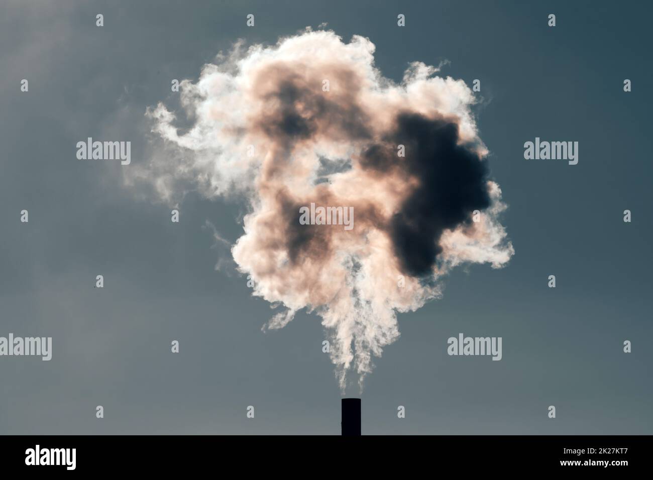 Smoke coming out of factory chimney Stock Photo - Alamy