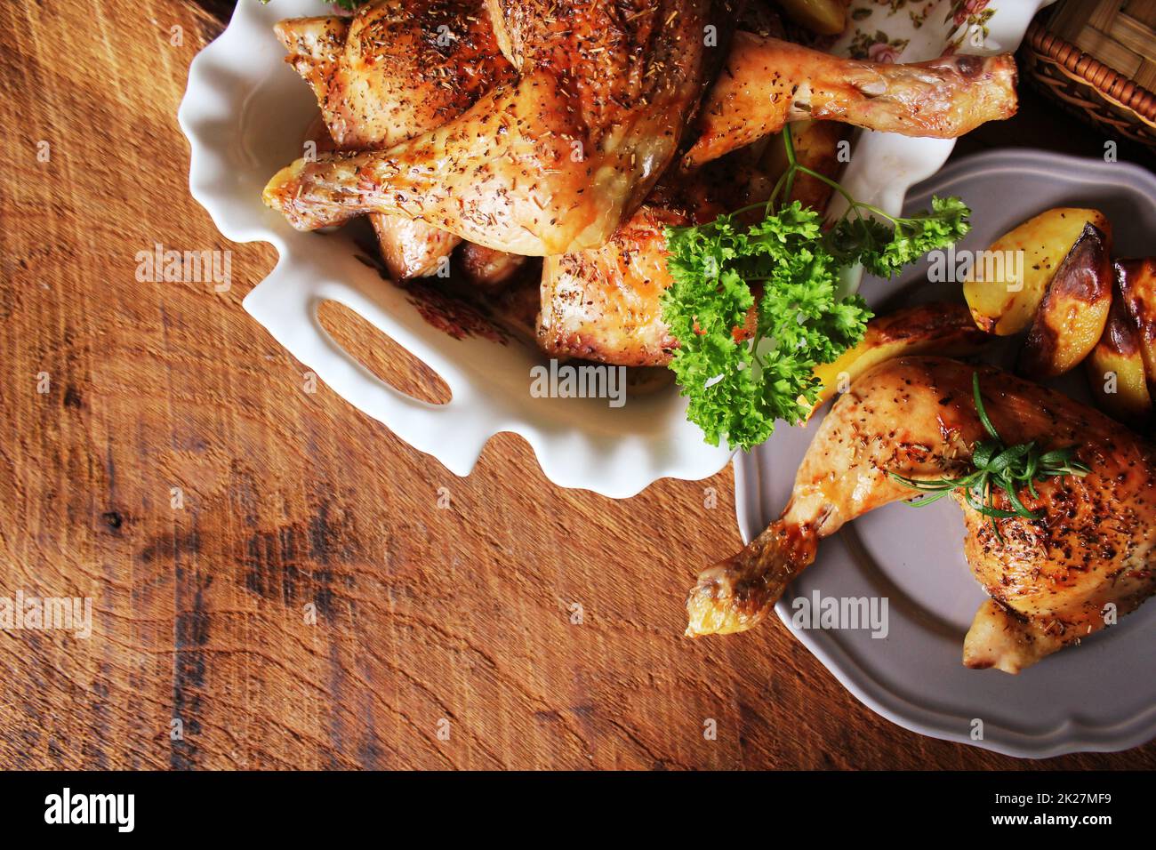 Grilled chicken leg with potato for garnish. Top view. Wooden ...