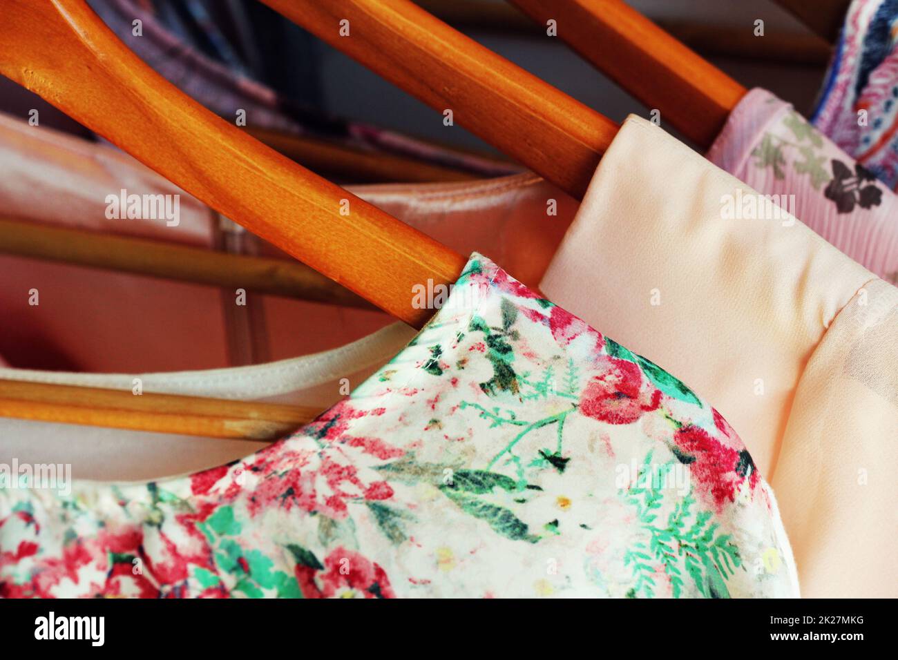 collection of women's clothes hanging on rack Stock Photo - Alamy