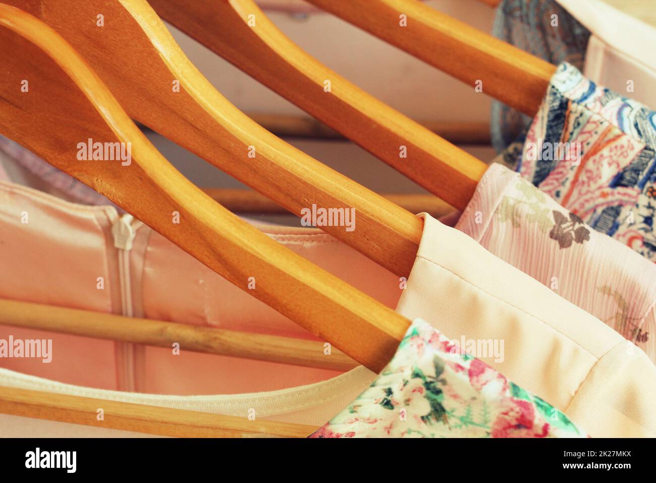 collection of women's clothes hanging on rack Stock Photo - Alamy