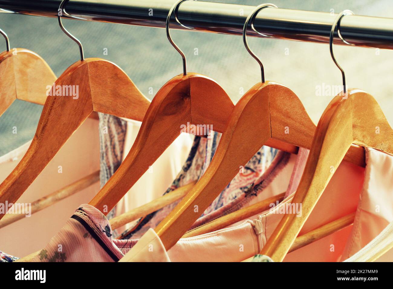 collection of women's clothes hanging on rack Stock Photo - Alamy