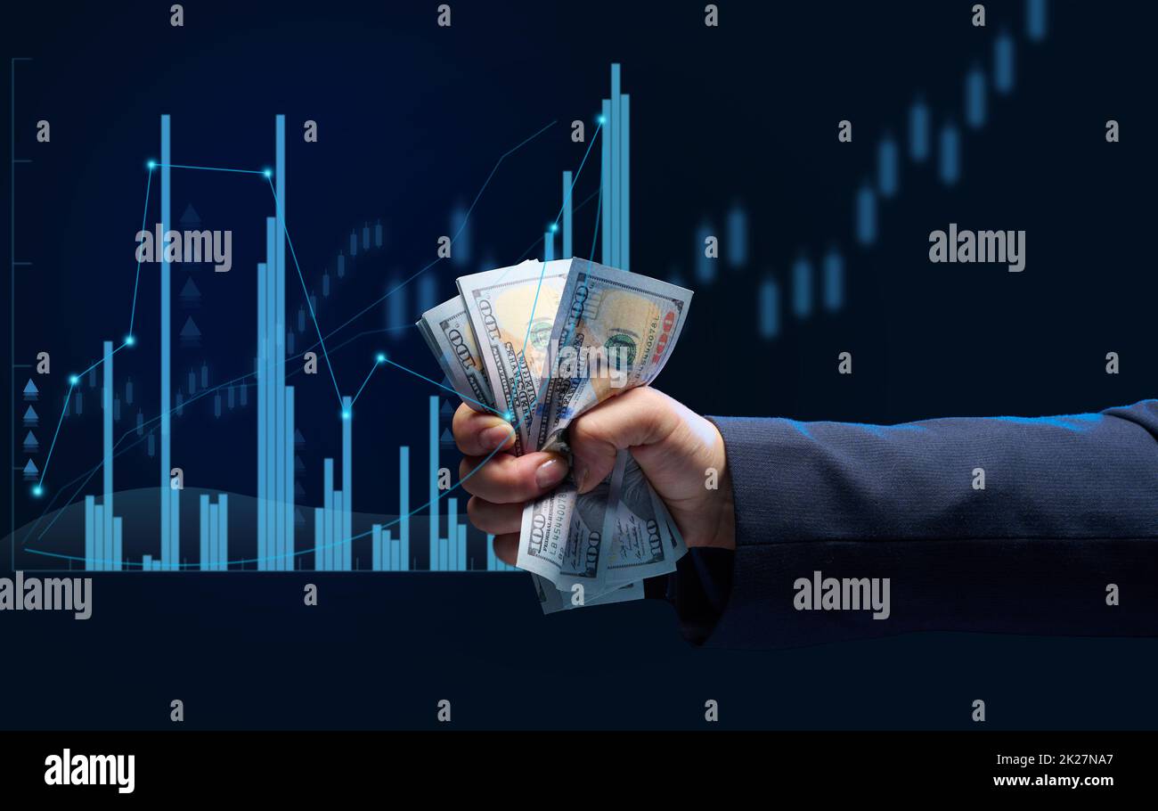 a female hand holds a stack of paper american dollars against the ...