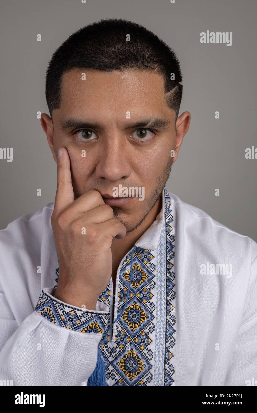 details of the face of a young man looking at the camera with an ...