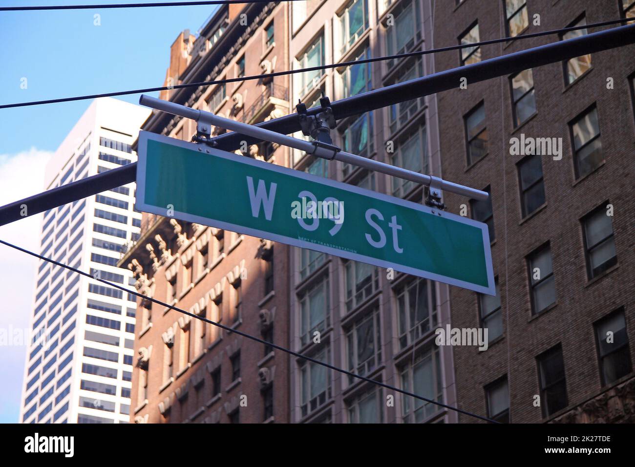 Green big West 39th Street sign hanging on a arch pole in the streets ...