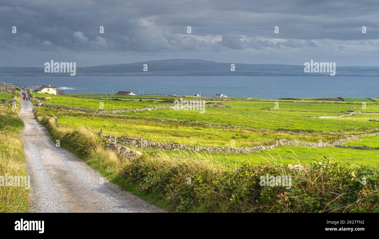 Tourists walking down the country road from popular attraction, iconic ...