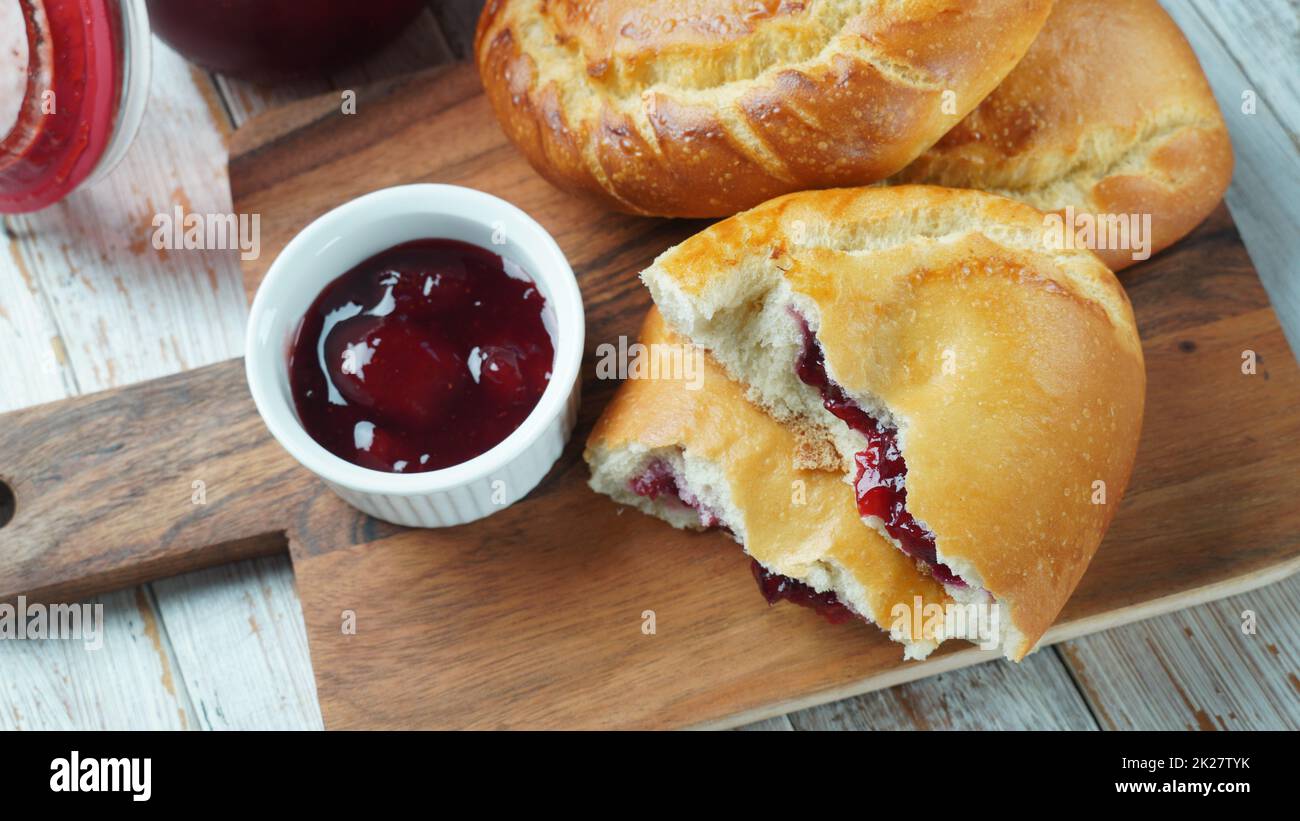 Cherry Pies stuffed with berries cherry, bowl with cherry jam. Homemade ...