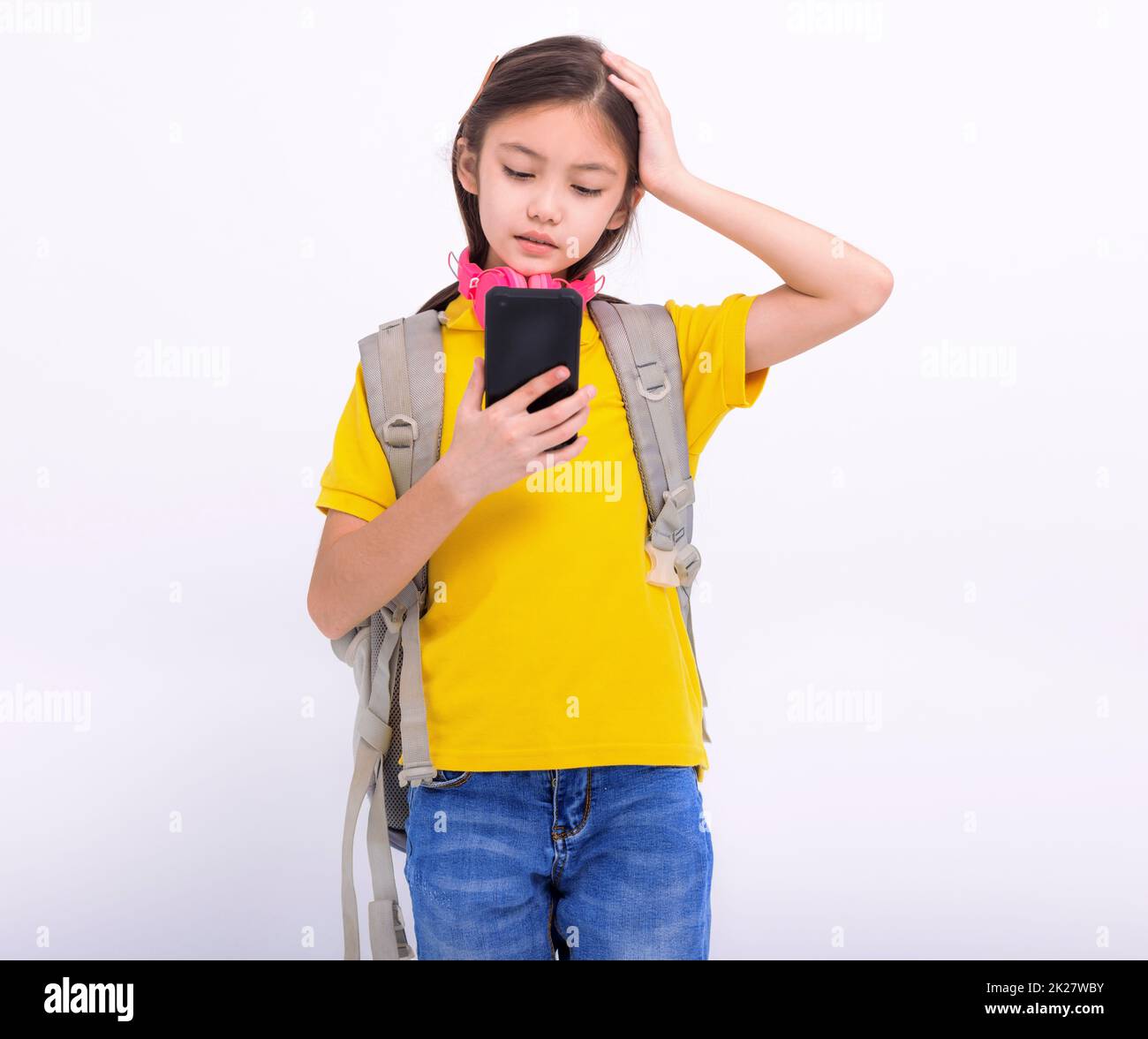 Confused student girl looking at smartphone . isolated on white background Stock Photo - Alamy