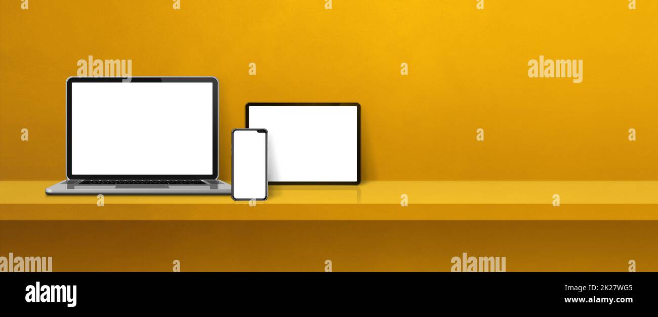Laptop, mobile phone and digital tablet pc on yellow wall shelf. Banner ...