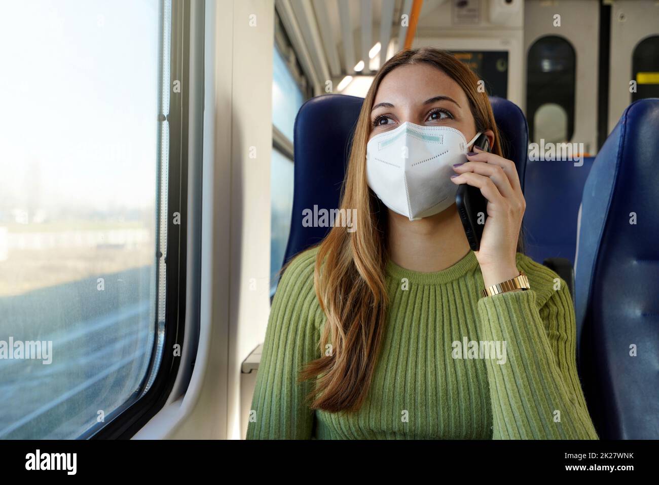 Young business woman wearing protective mask required for public ...
