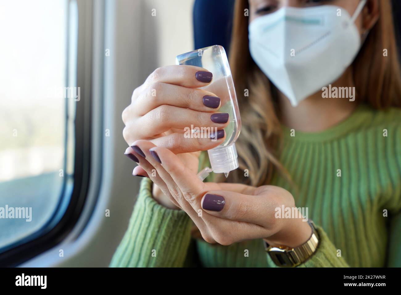 Business woman with medical face mask using alcohol gel sanitizing ...