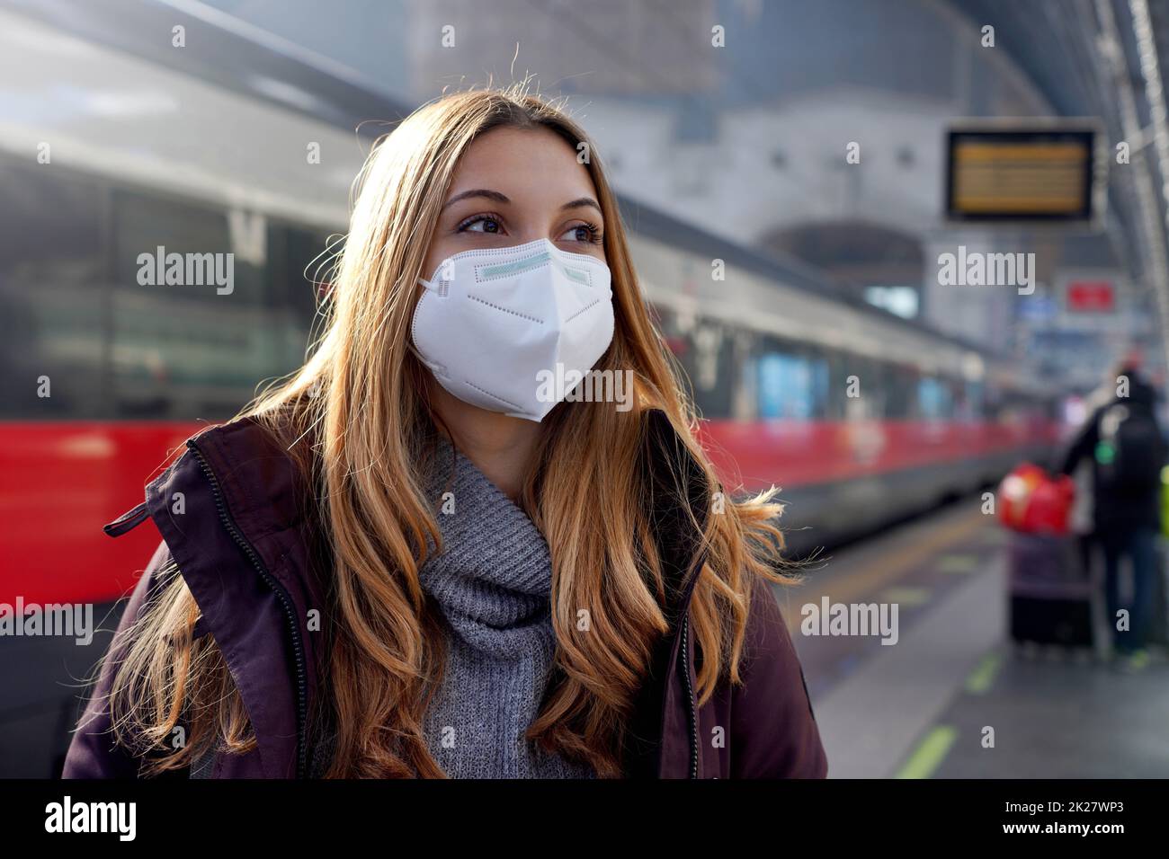 Portrait of girl wearing KN95 FFP2 medical face mask with moving train ...