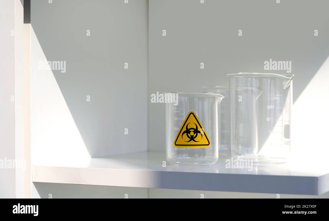 Beaker with biohazard symbol on a white shelf in laboratory Stock Photo ...