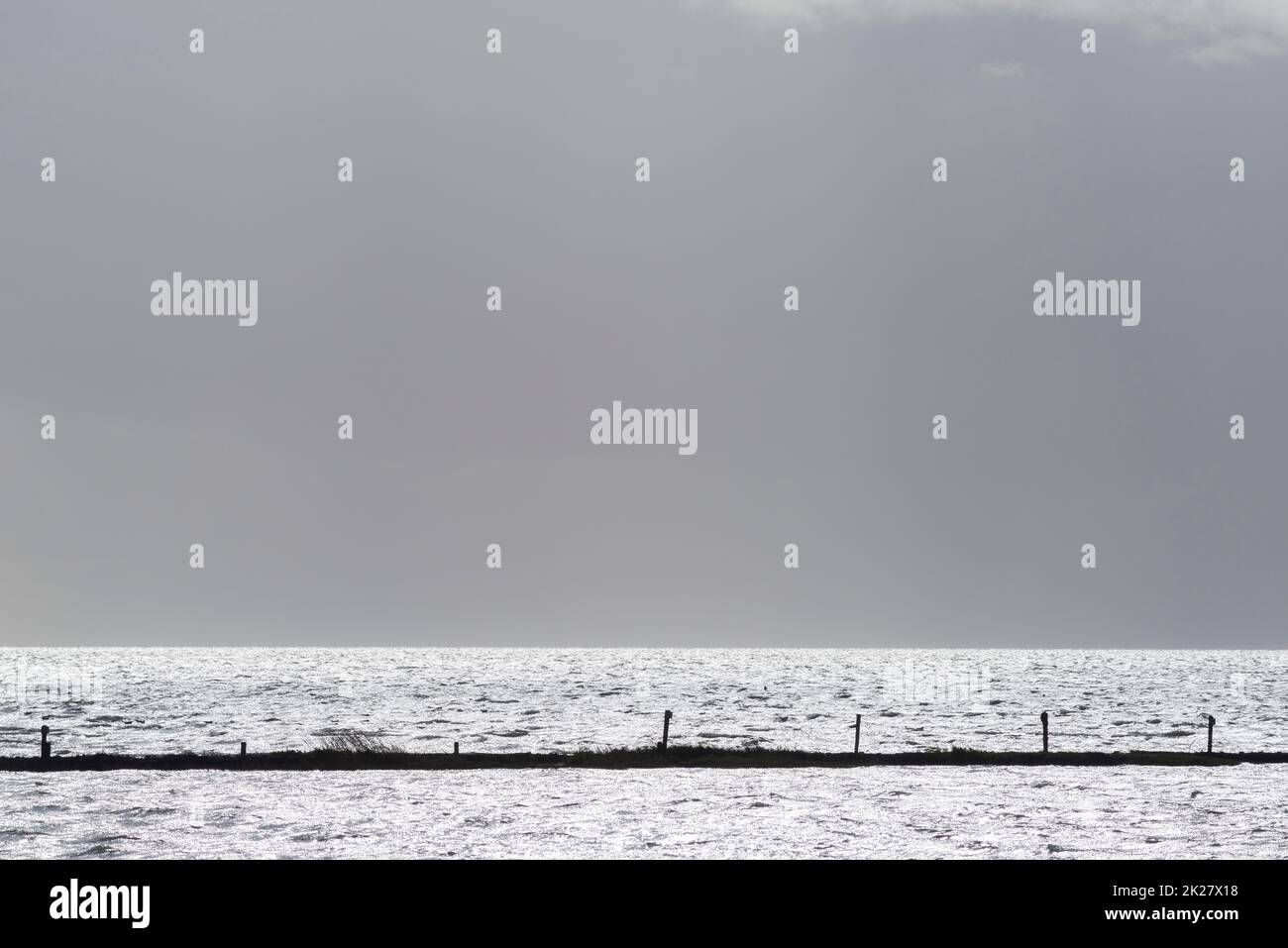 Open sea with flooded salt meadows and groyn, seen from the peninsula ...