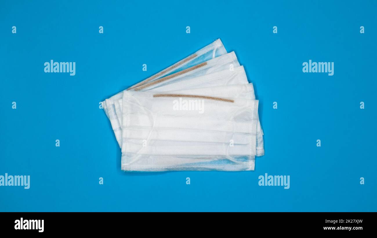 Three disposable surgical face masks with rubber pads to cover the ...