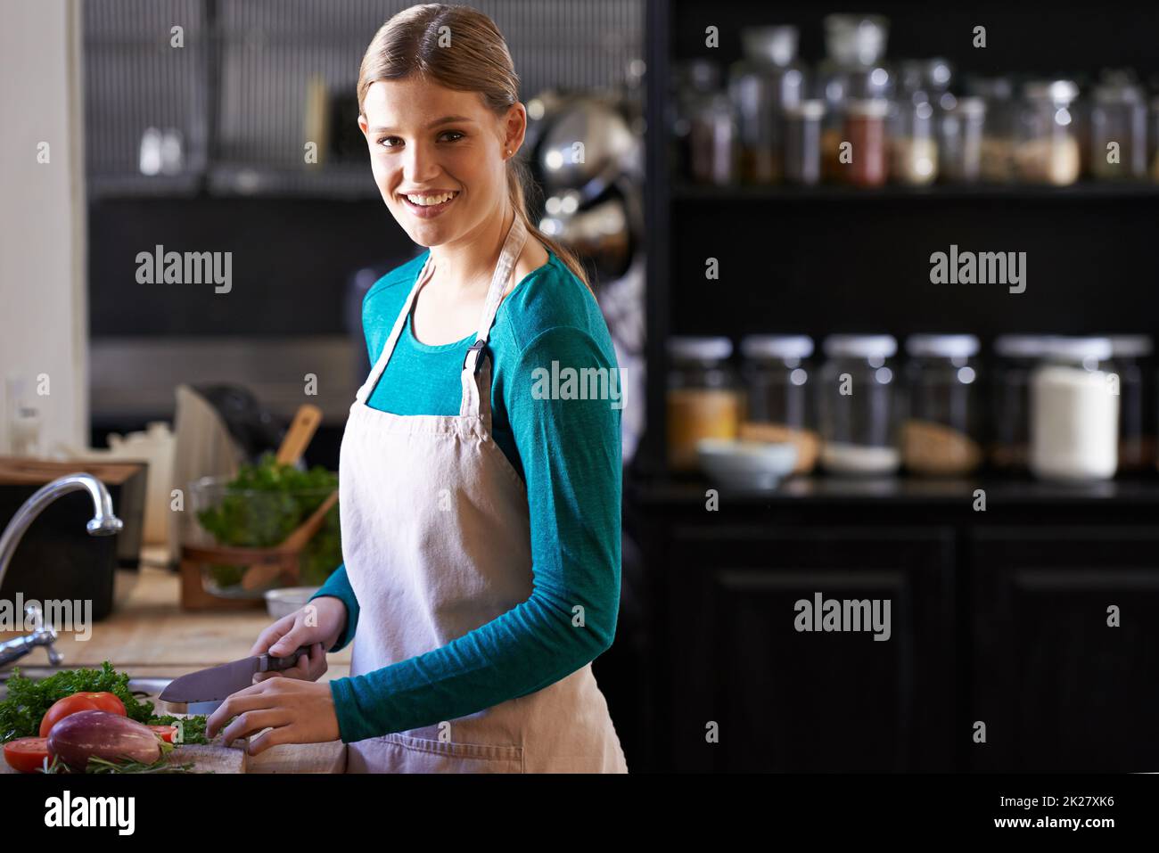 Preparing a wholesome meal. Portrait of an attractive young woman ...