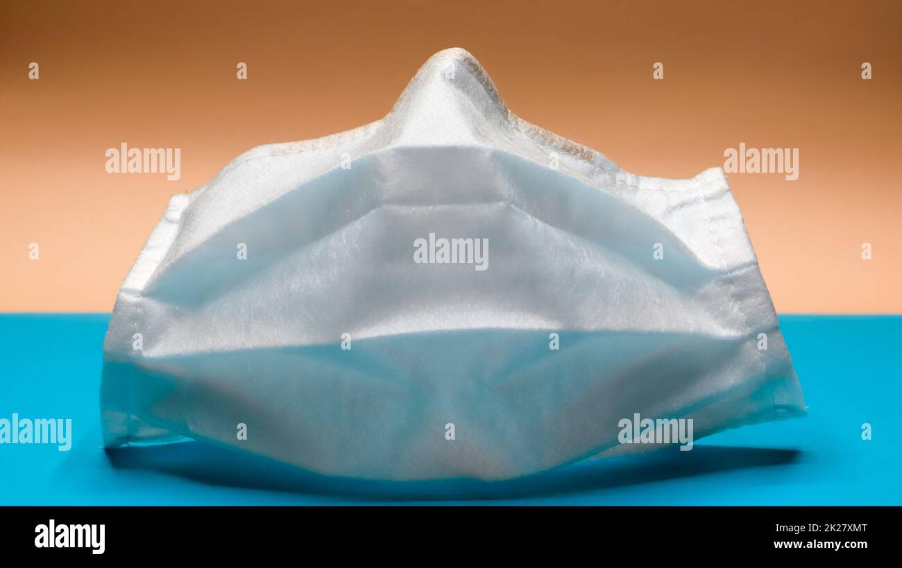 One 3-layer disposable surgical face mask with rubber pads to cover the ...