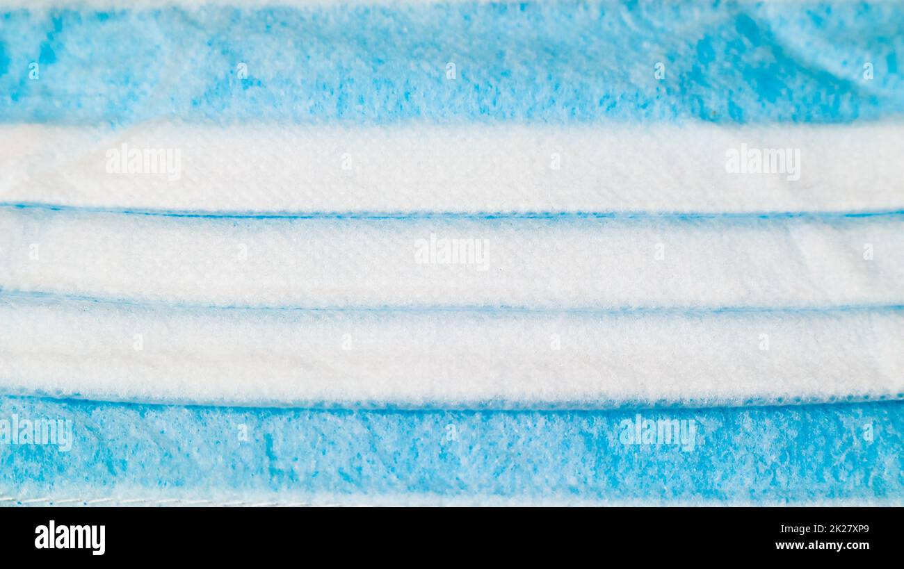 One 3-ply disposable surgical face mask close-up with rubber pads ...