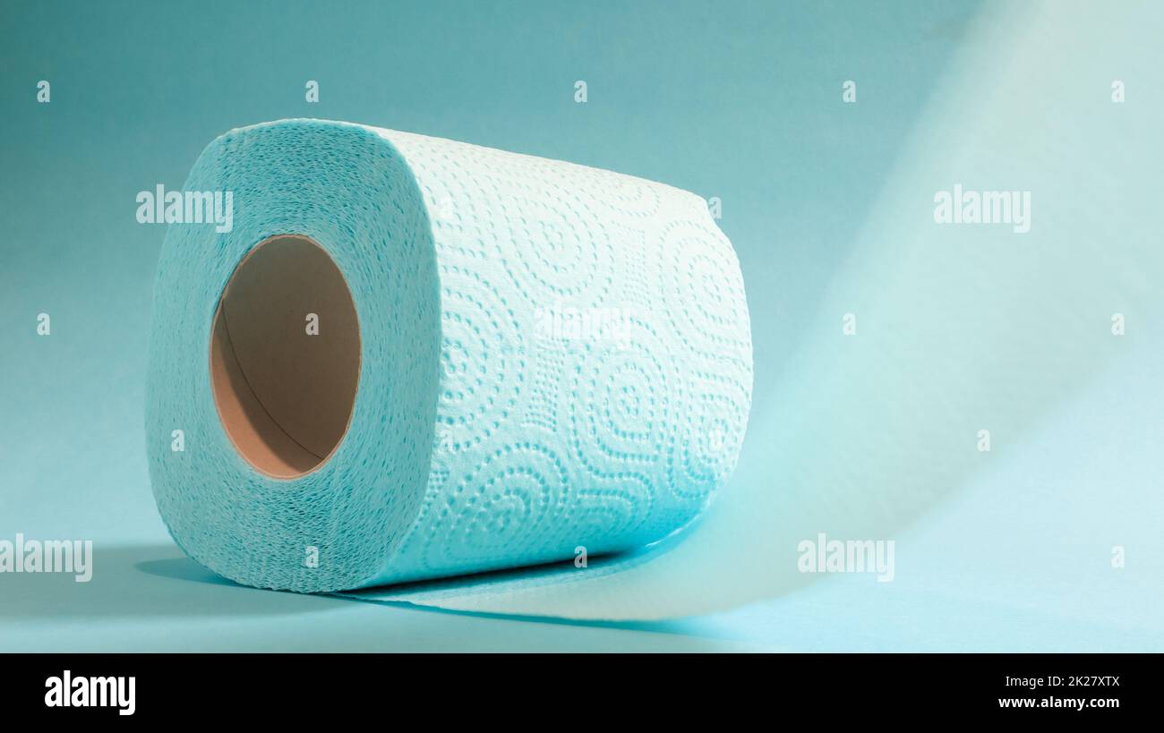 Blue roll of modern toilet paper on a blue background. A paper product ...
