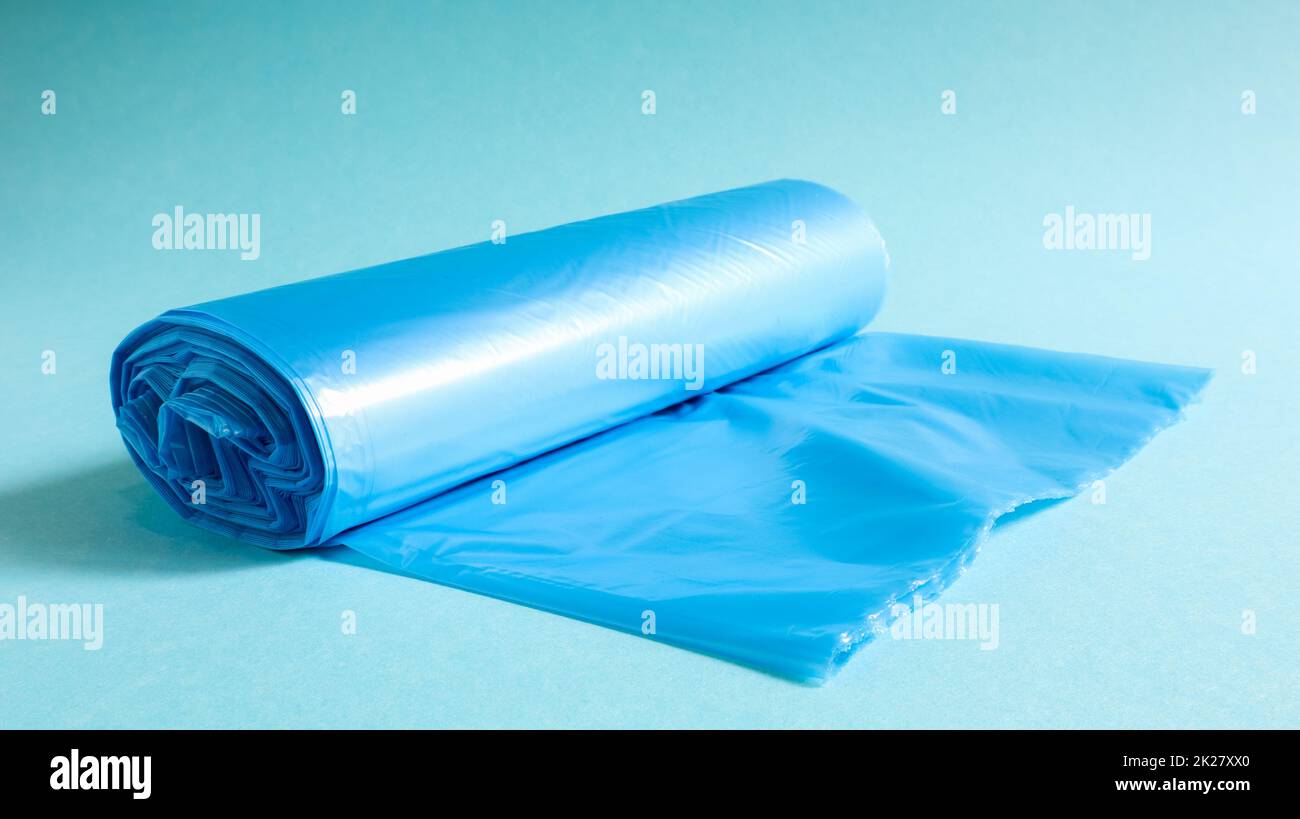 One roll of plastic garbage bags in blue on a blue background. Bags ...