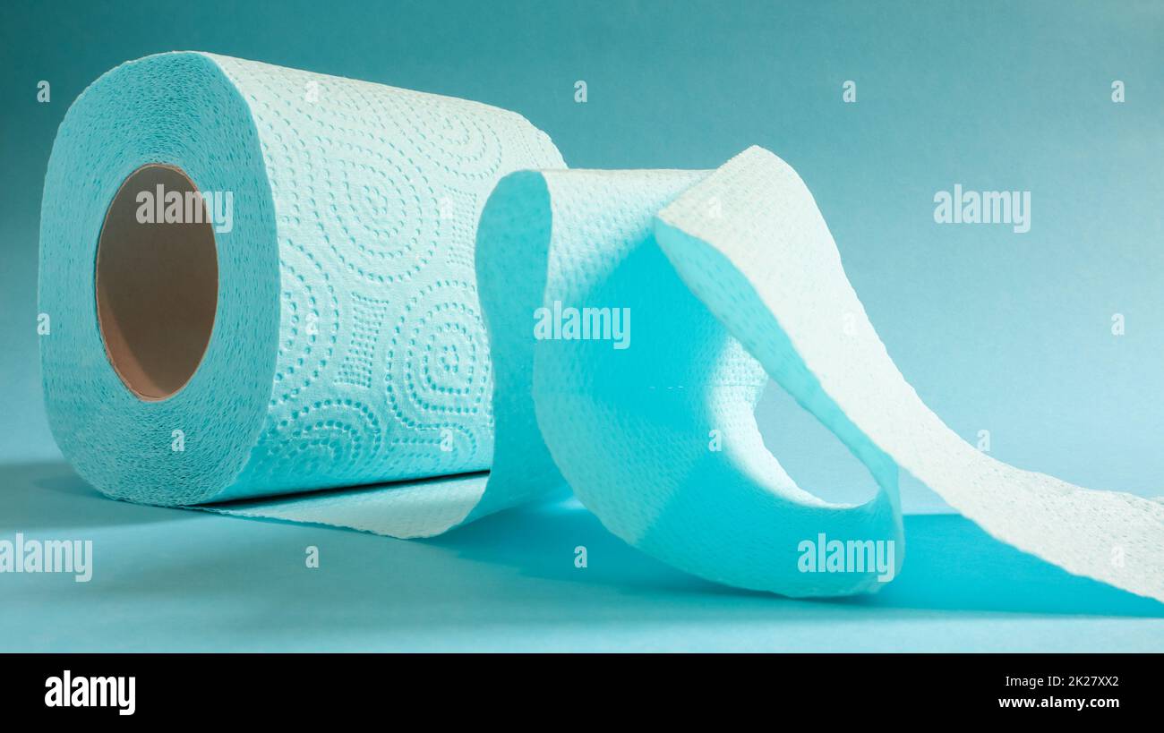 Blue roll of modern toilet paper on a blue background. A paper product ...