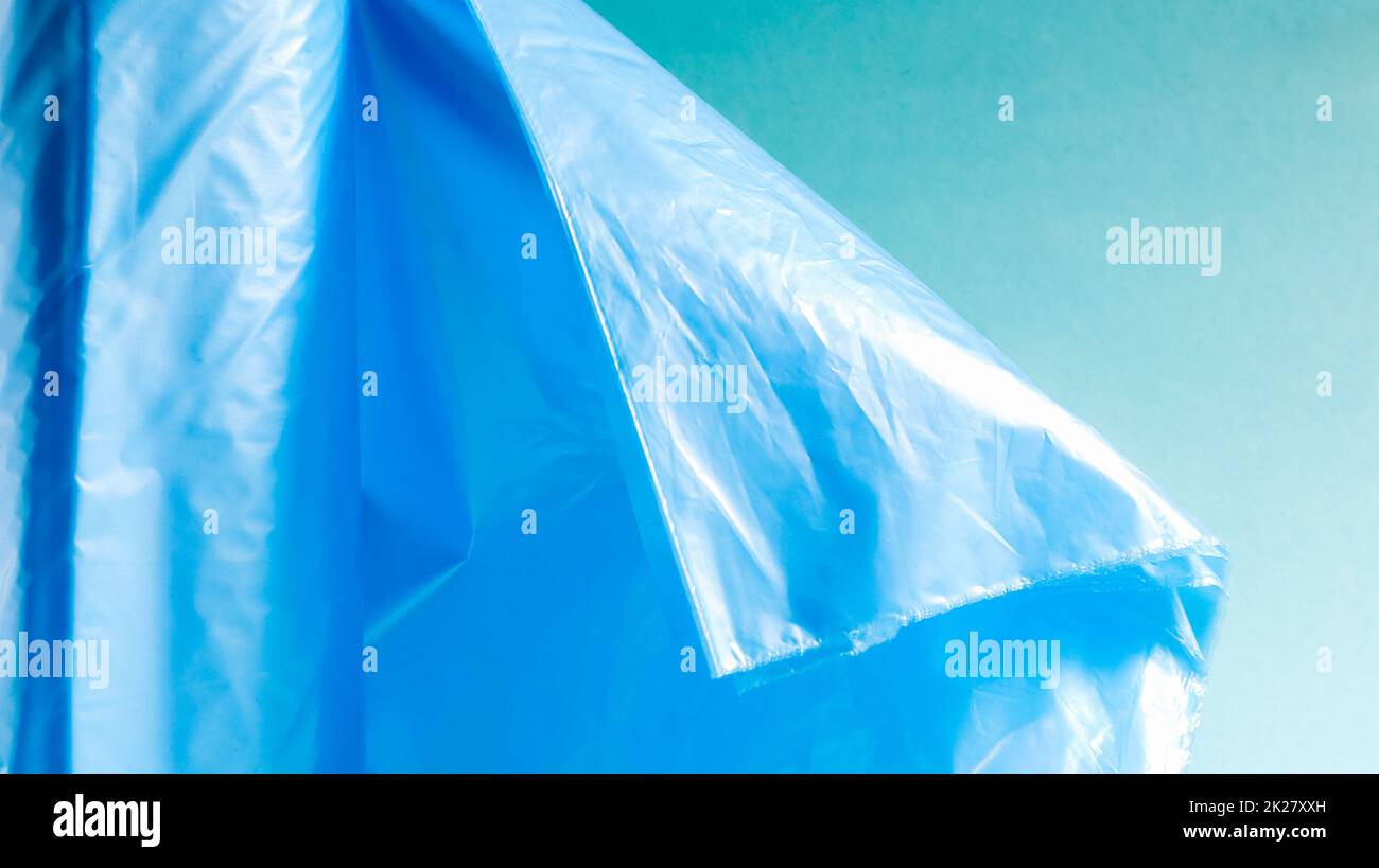 One roll of plastic garbage bags in blue on a blue background. Bags ...