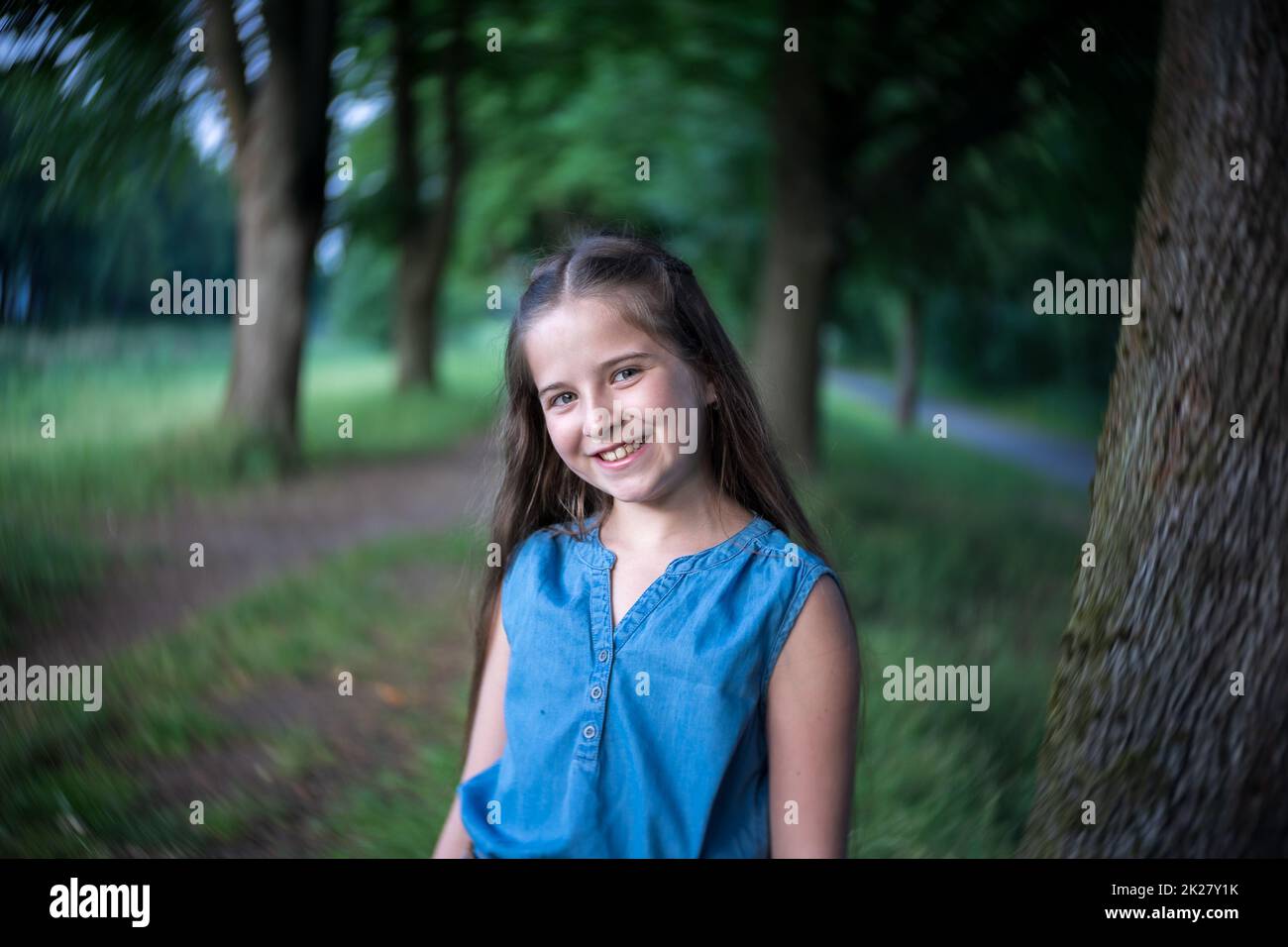 Portrait of a beautiful girl with long hair in nature Stock Photo - Alamy