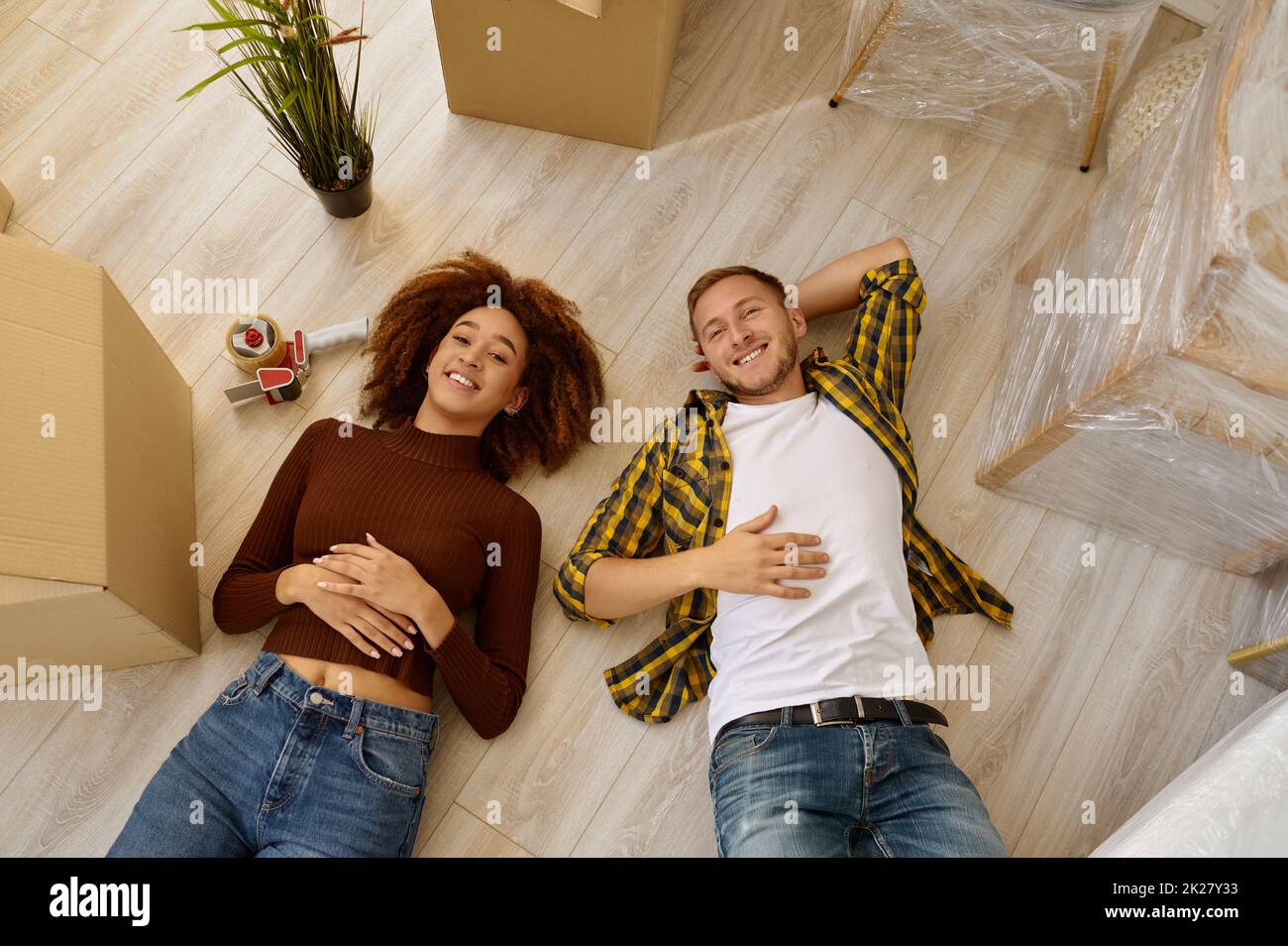 Happy couple on floor view from above Stock Photo - Alamy
