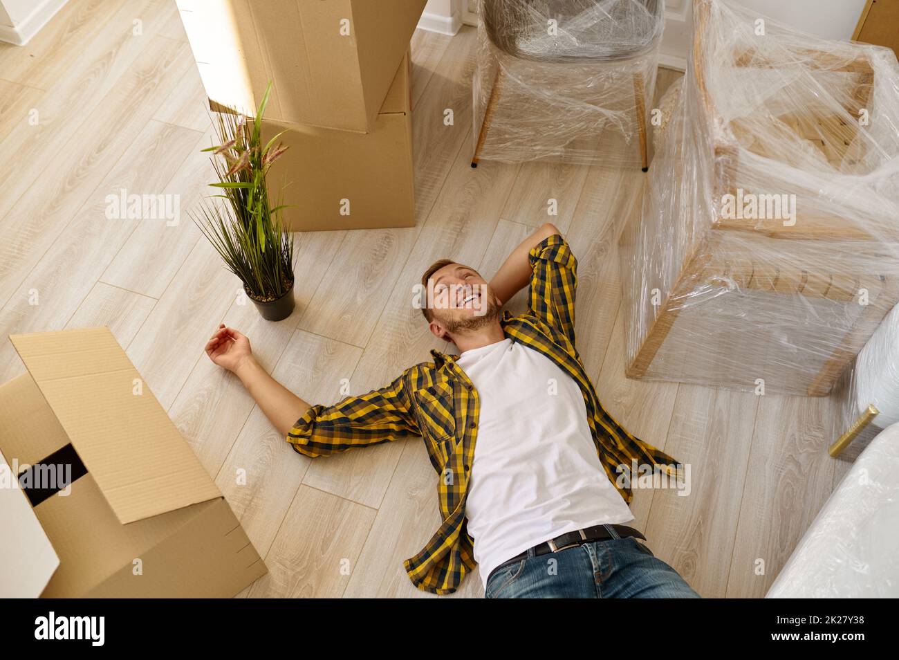 Happy man on floor moving new home Stock Photo - Alamy