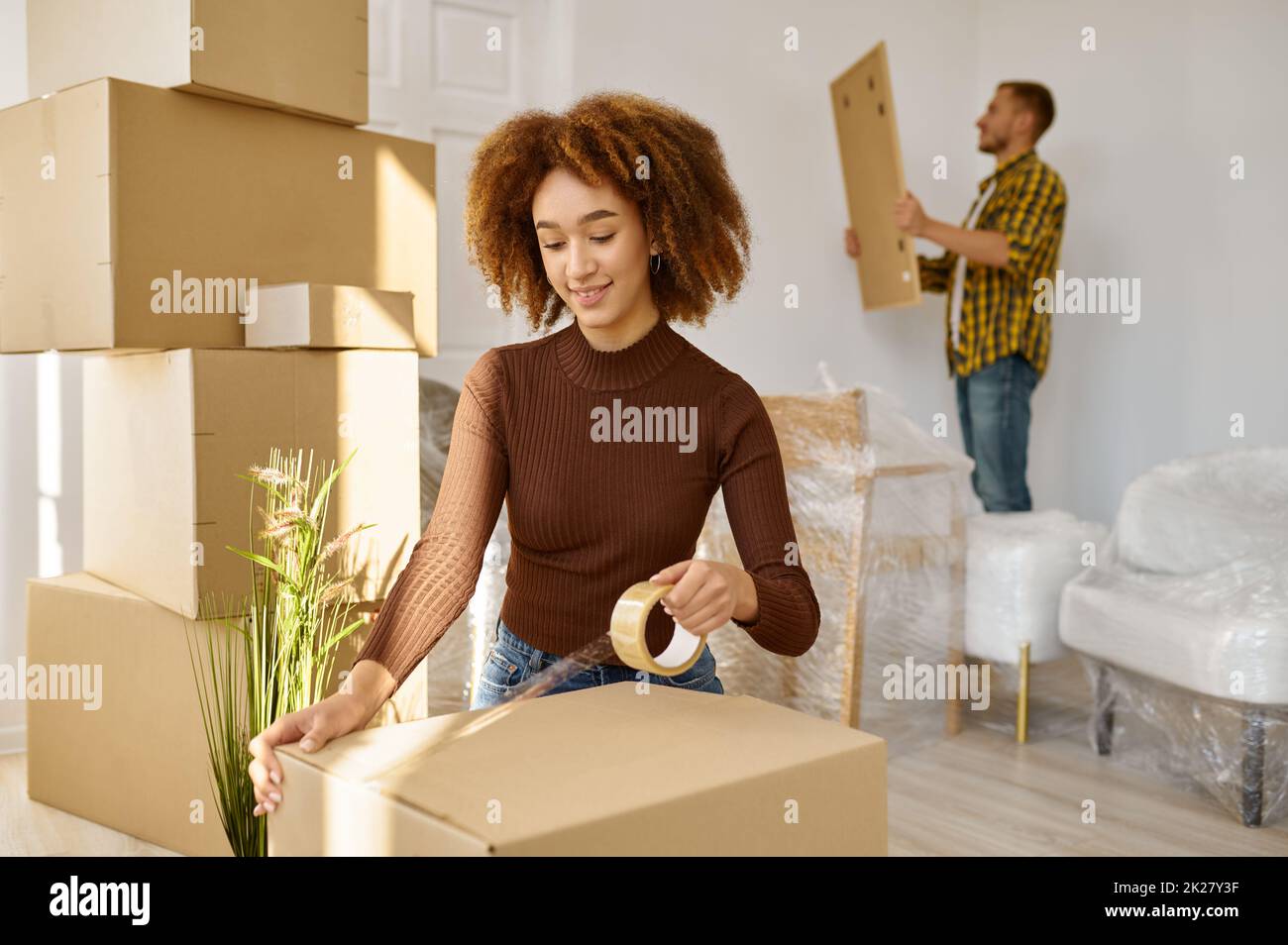 Young couple packing stuff into carton boxes Stock Photo - Alamy