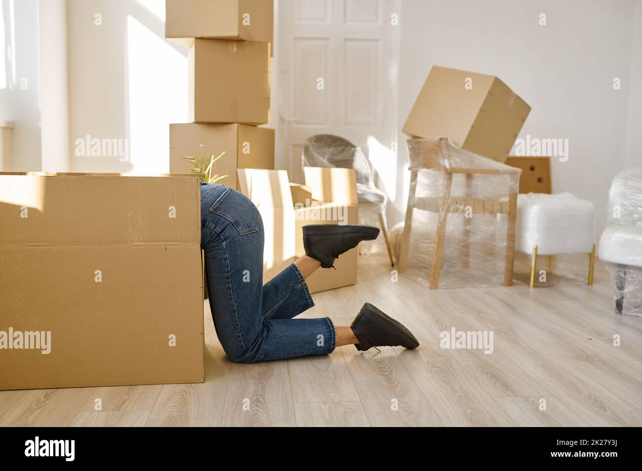 Funny woman looking something in big box Stock Photo - Alamy