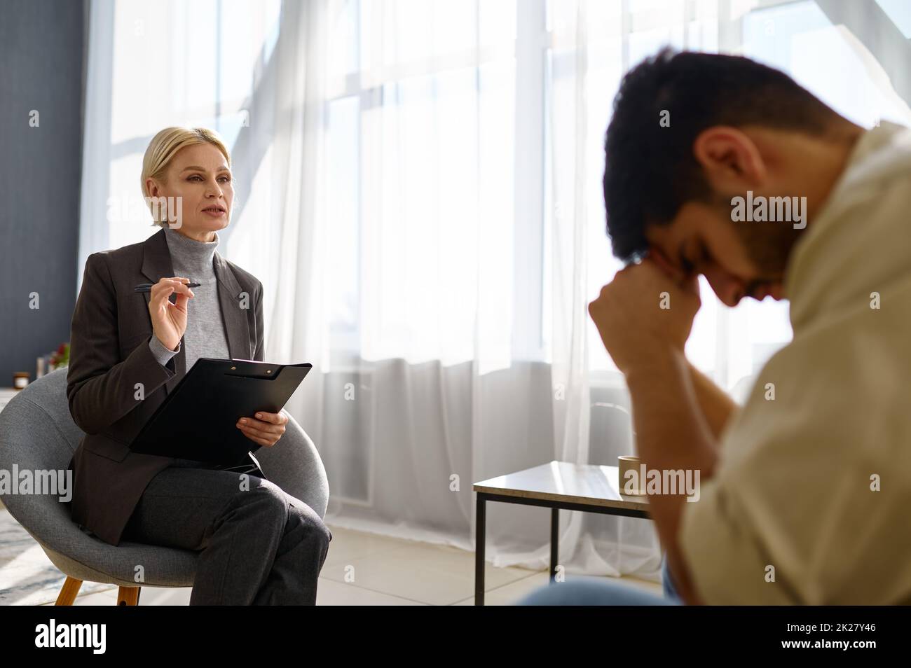 Psychologist talking to depressed frustrated unhappy man Stock Photo ...