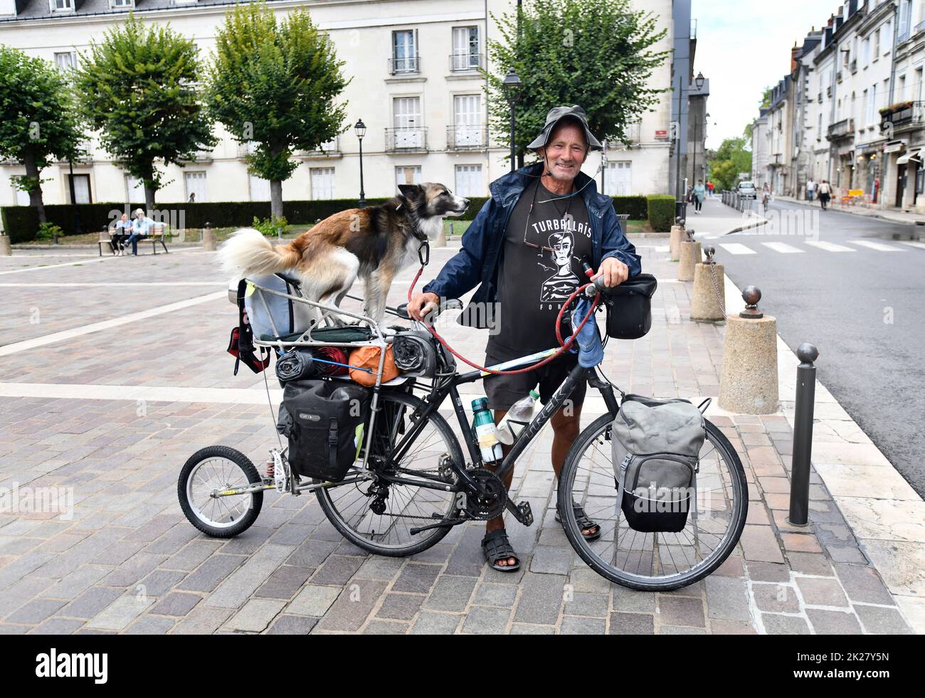 Man travelling around the city of Tours in France on his bycycle with ...