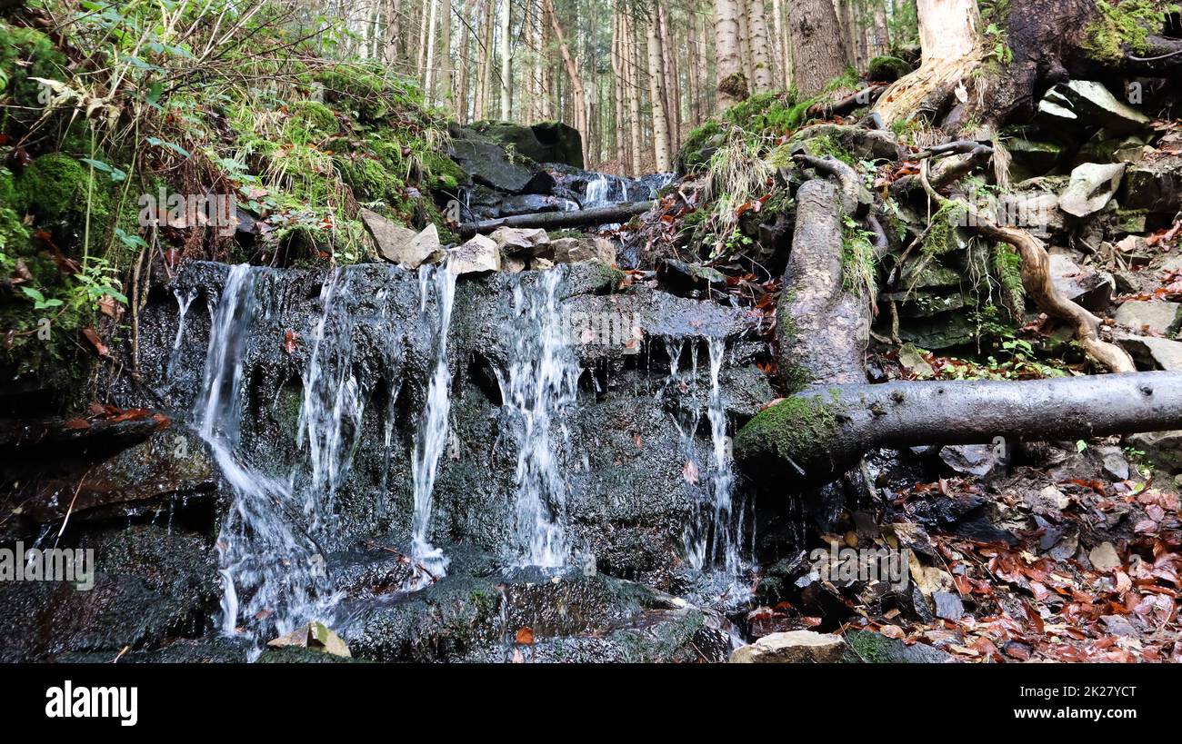 Waterfalls in a small canyon with stone walls. Beautiful cascade in the ...
