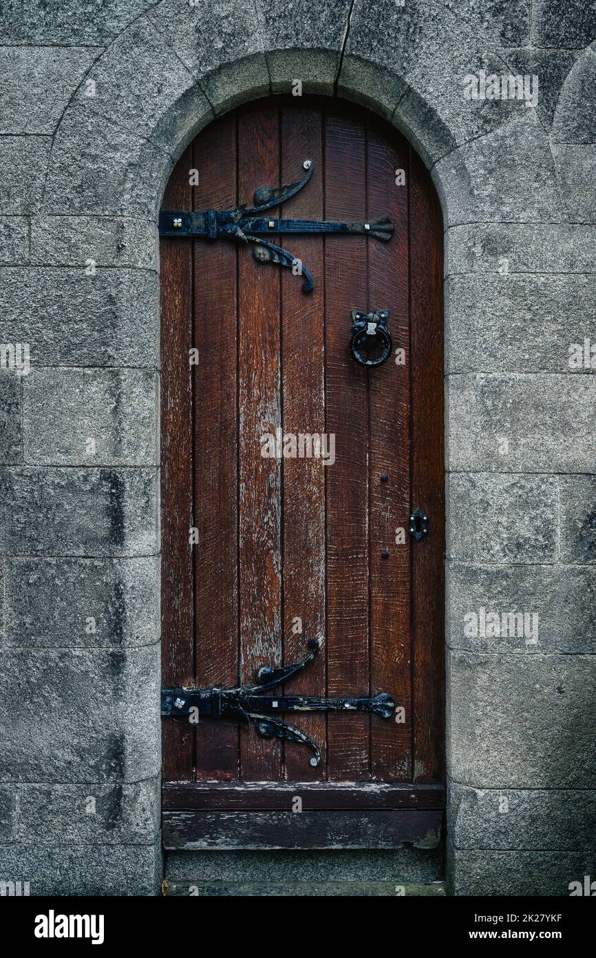 Vintage, old wooden door in Gothic style with iron hinge and frame in ...