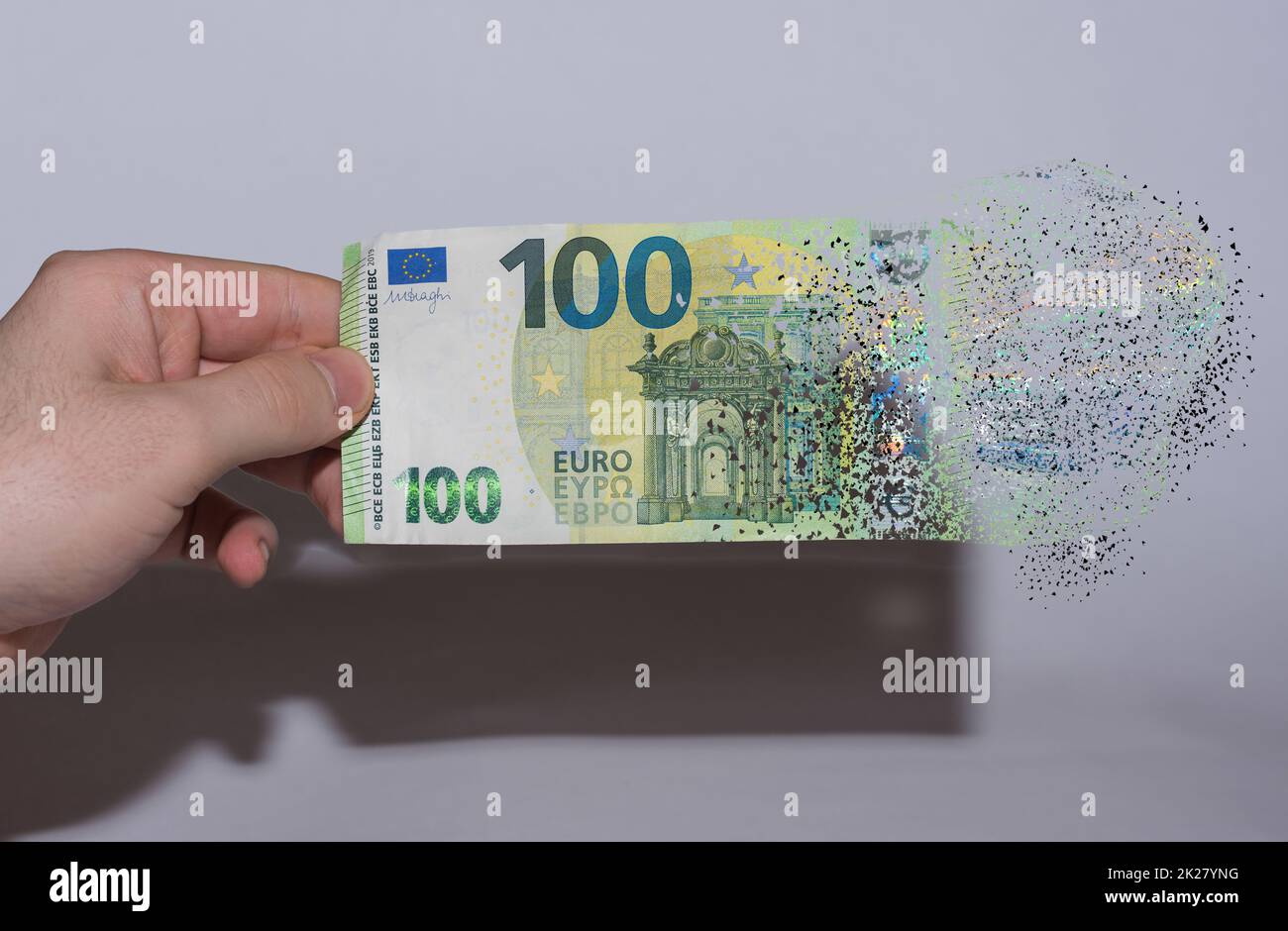 euro bill held in one hand decomposes and dissolves due to inflation ...
