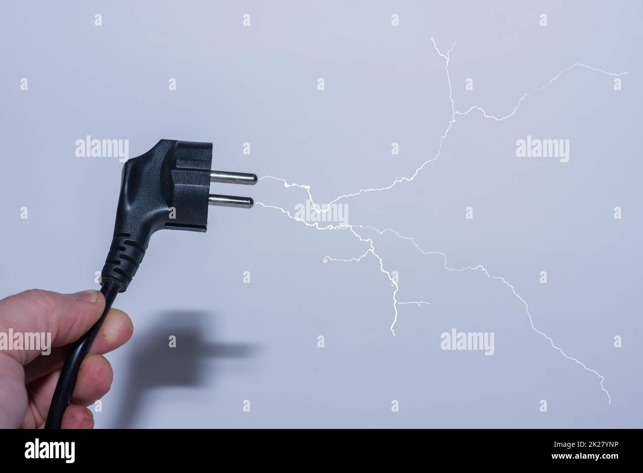 plug in one hand save electricity and a branched lightning Stock Photo ...