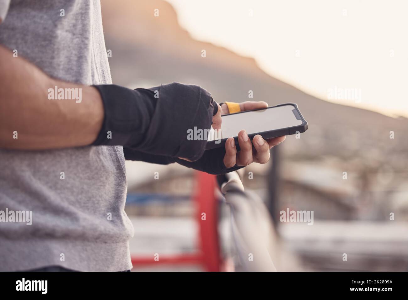 Gym man, typing and phone screen at boxing fitness training practice ...