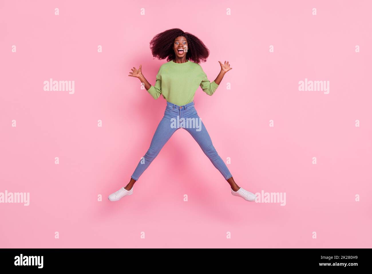Full length photo of sweet impressed lady wear green sweater jumping ...