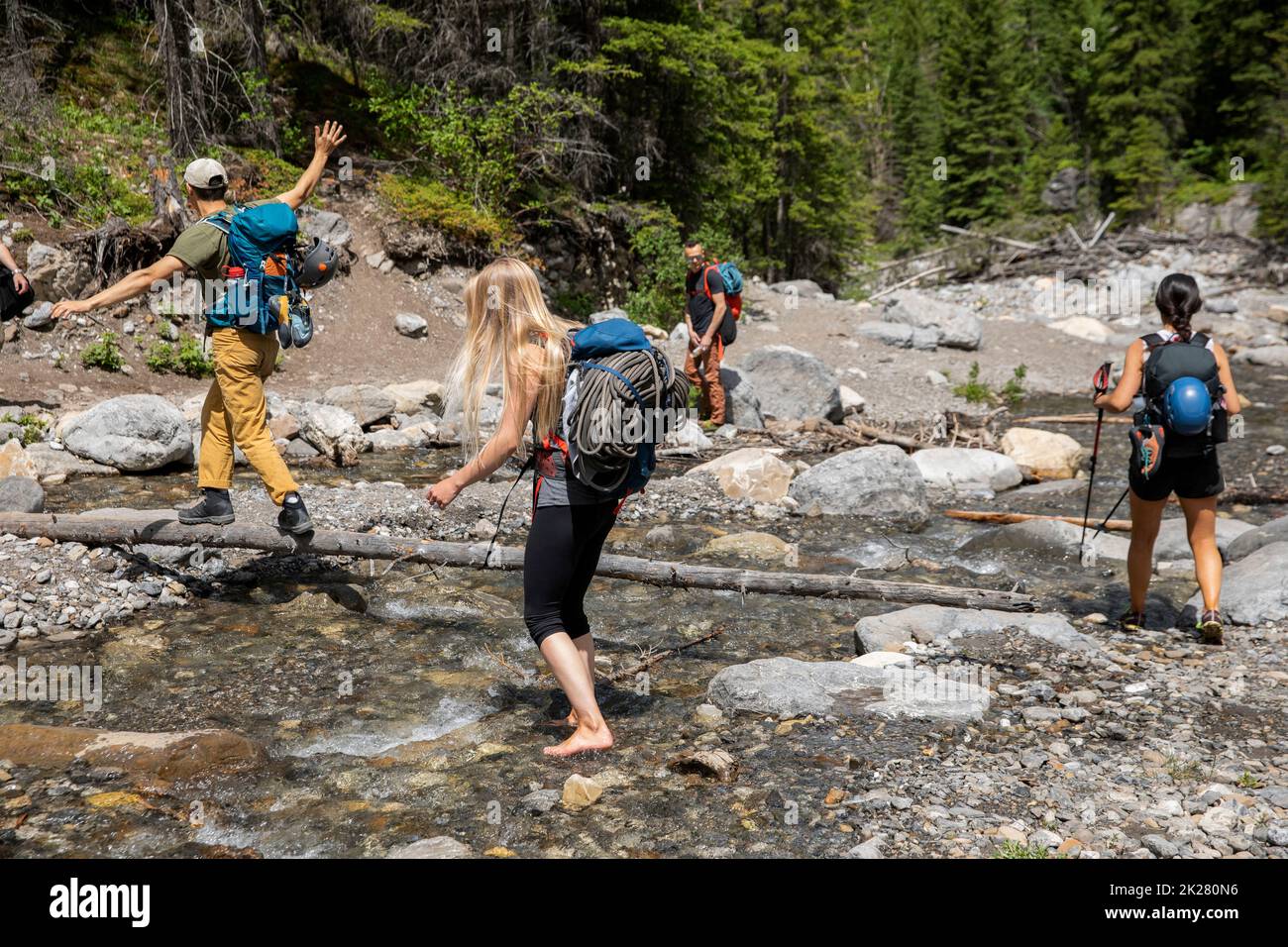 Young woman crossing a river hi-res stock photography and images - Alamy