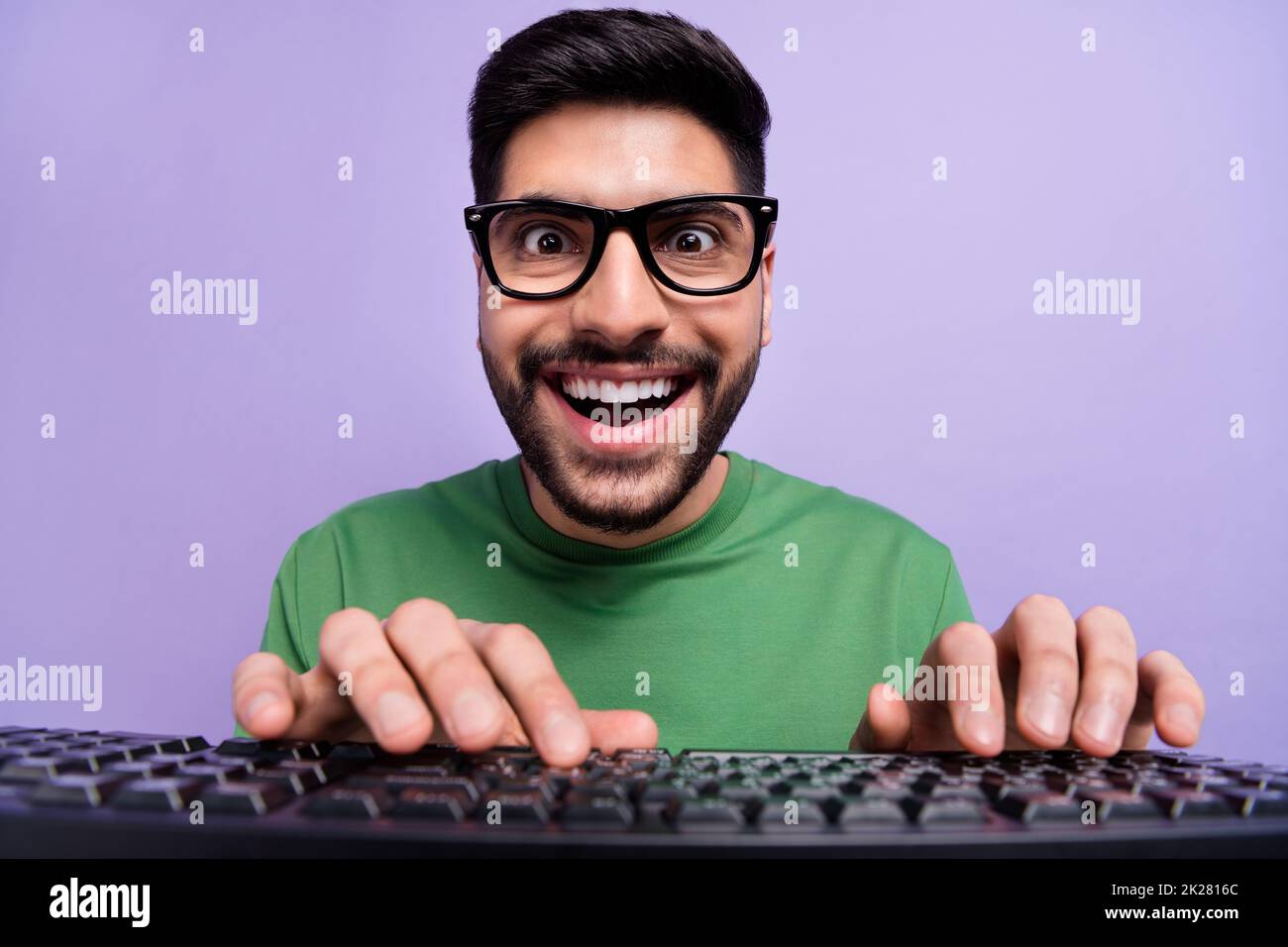 Photo of handsome geek nerd coder in spectacles green pullover writing ...